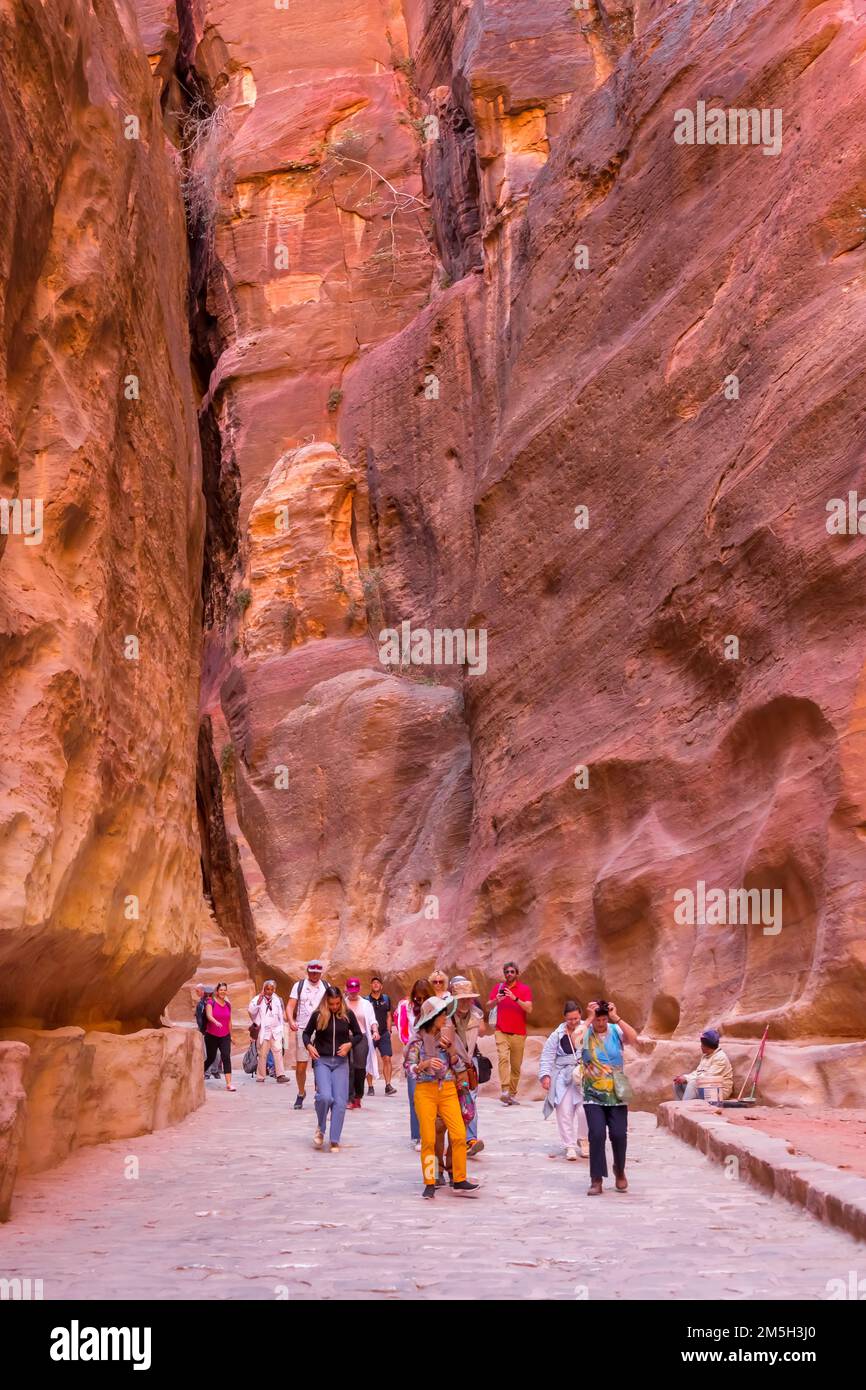 Petra, Jordan - November 3, 2022: People tourists walking along Siq walls to the Treasury, Al ...