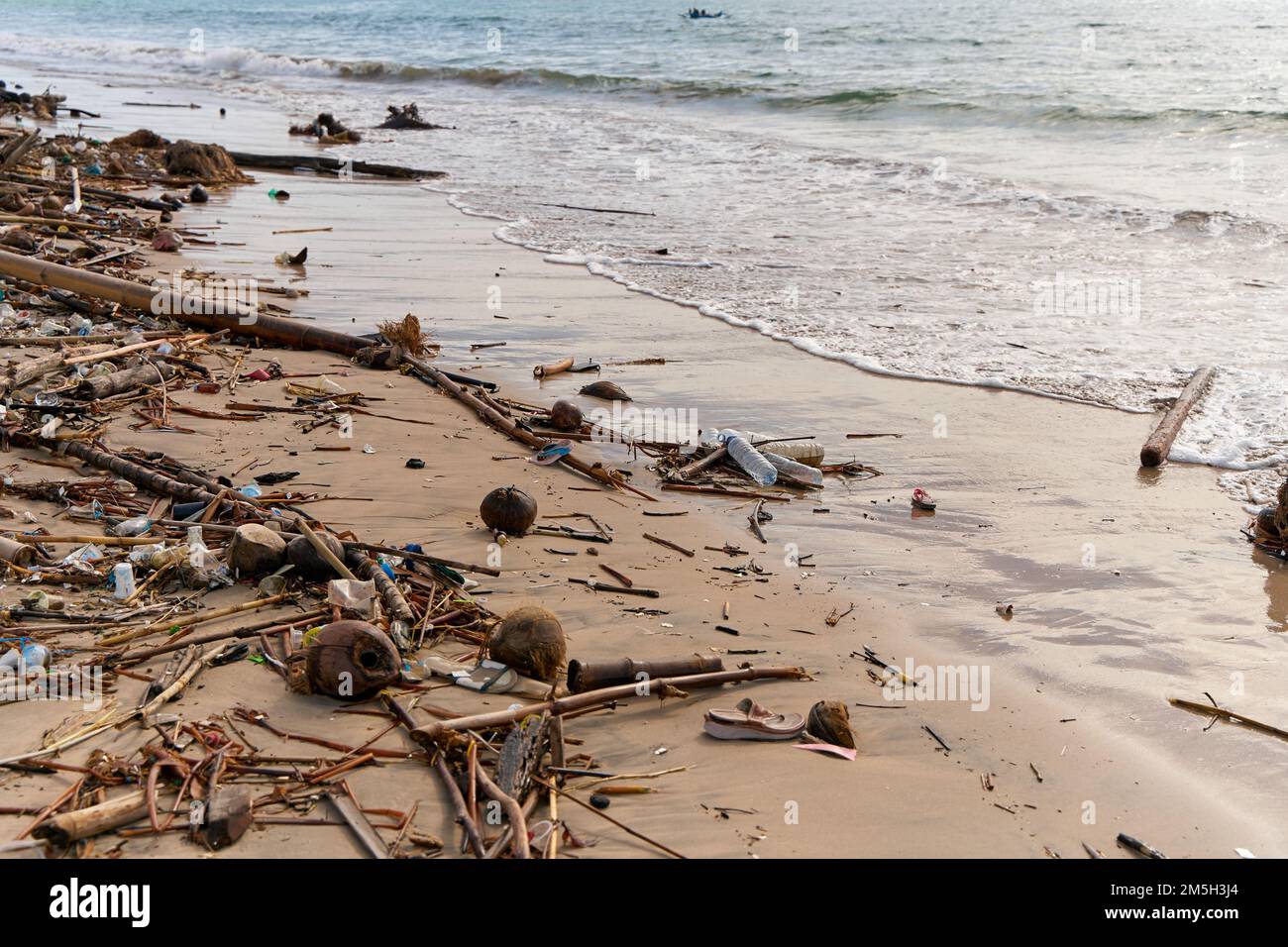 Mountains of waste and garbage on the sandy beach after the tide ...