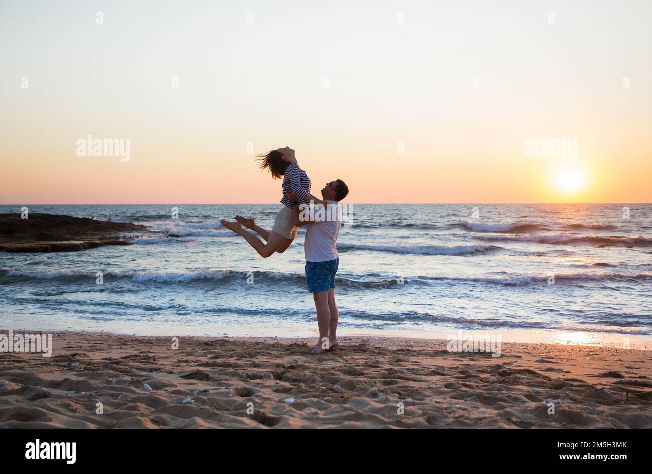man and woman, couple in love, in full growth are actively having fun ...