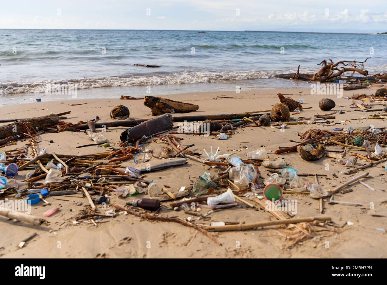 Mountains of waste and garbage on the sandy beach after the tide ...