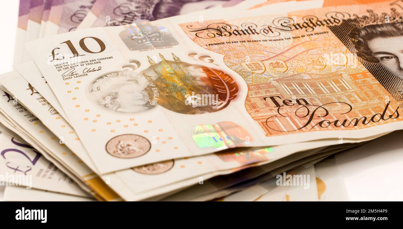 A closeup of en and twenty pound notes protruding Stock Photo - Alamy