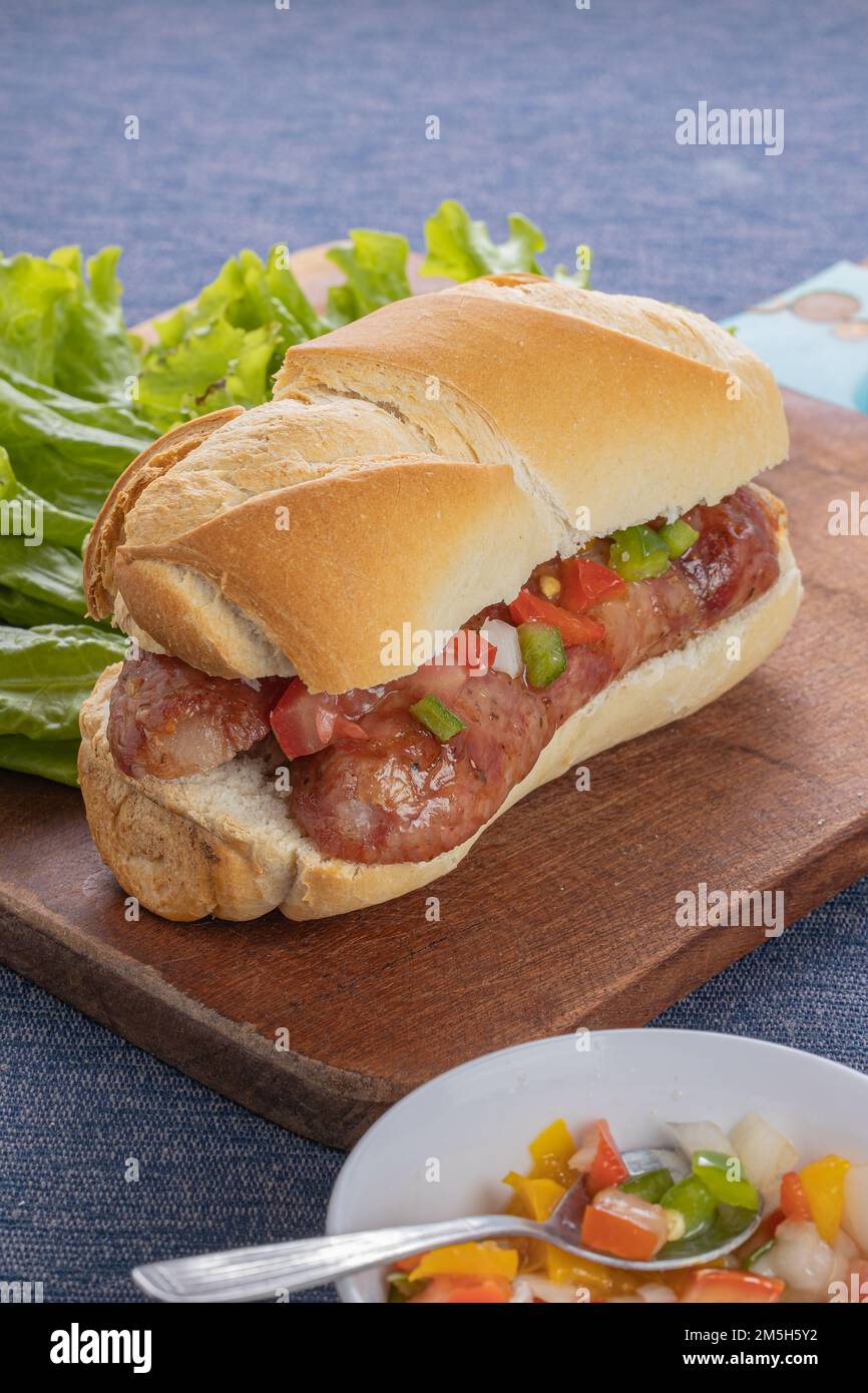 Choripan, typical argentine sandwich with chorizo and creole sauce ...