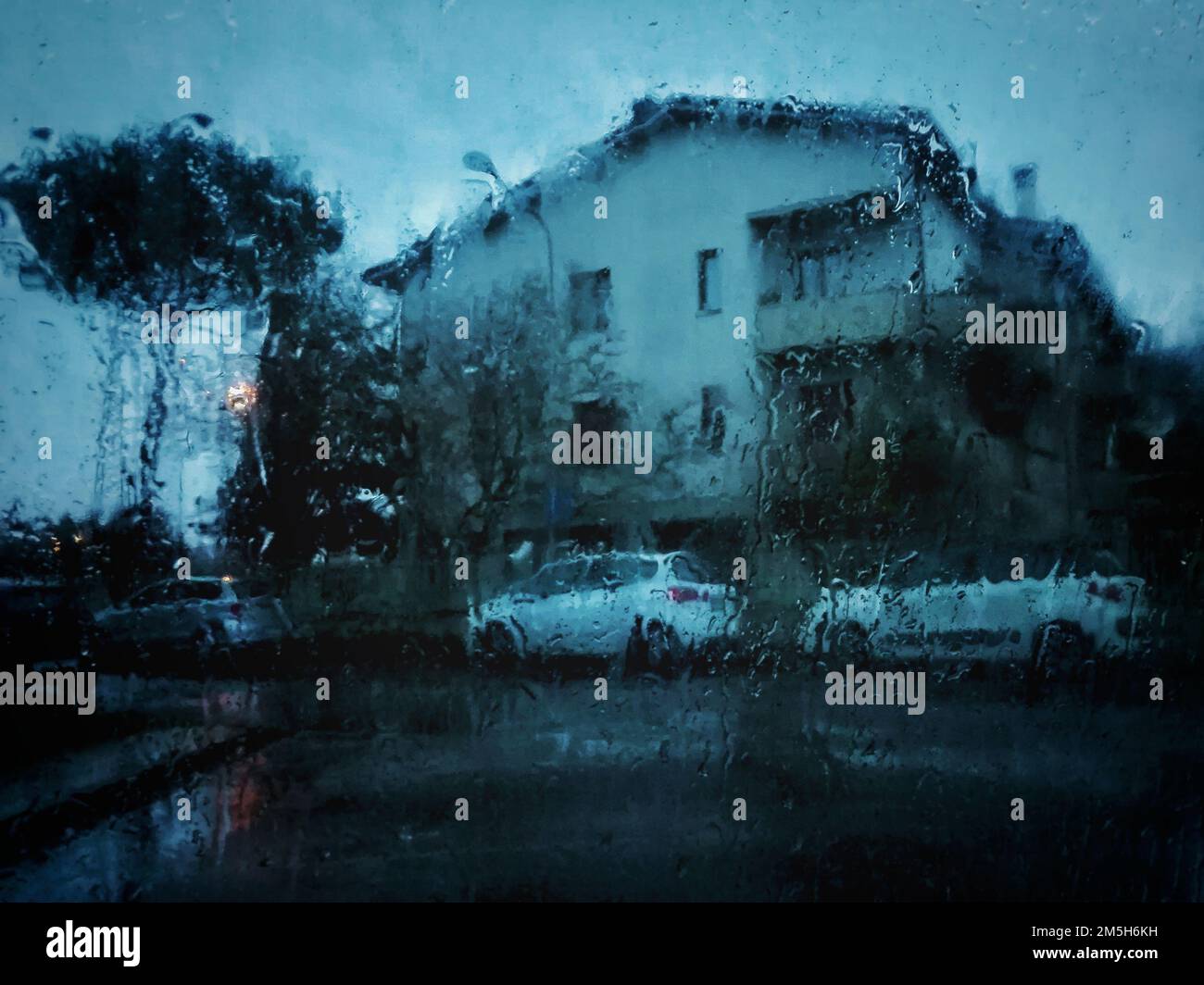 window during a cloudy rainy day of summer. window with rain droplets ...