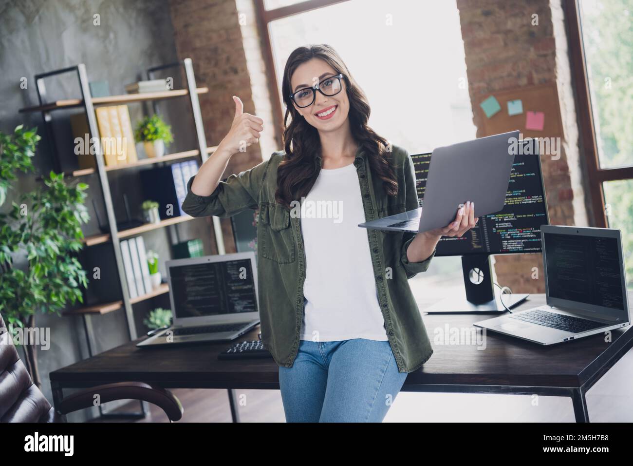 Photo of web designer software expert smart lady hold netbook thumb up ...