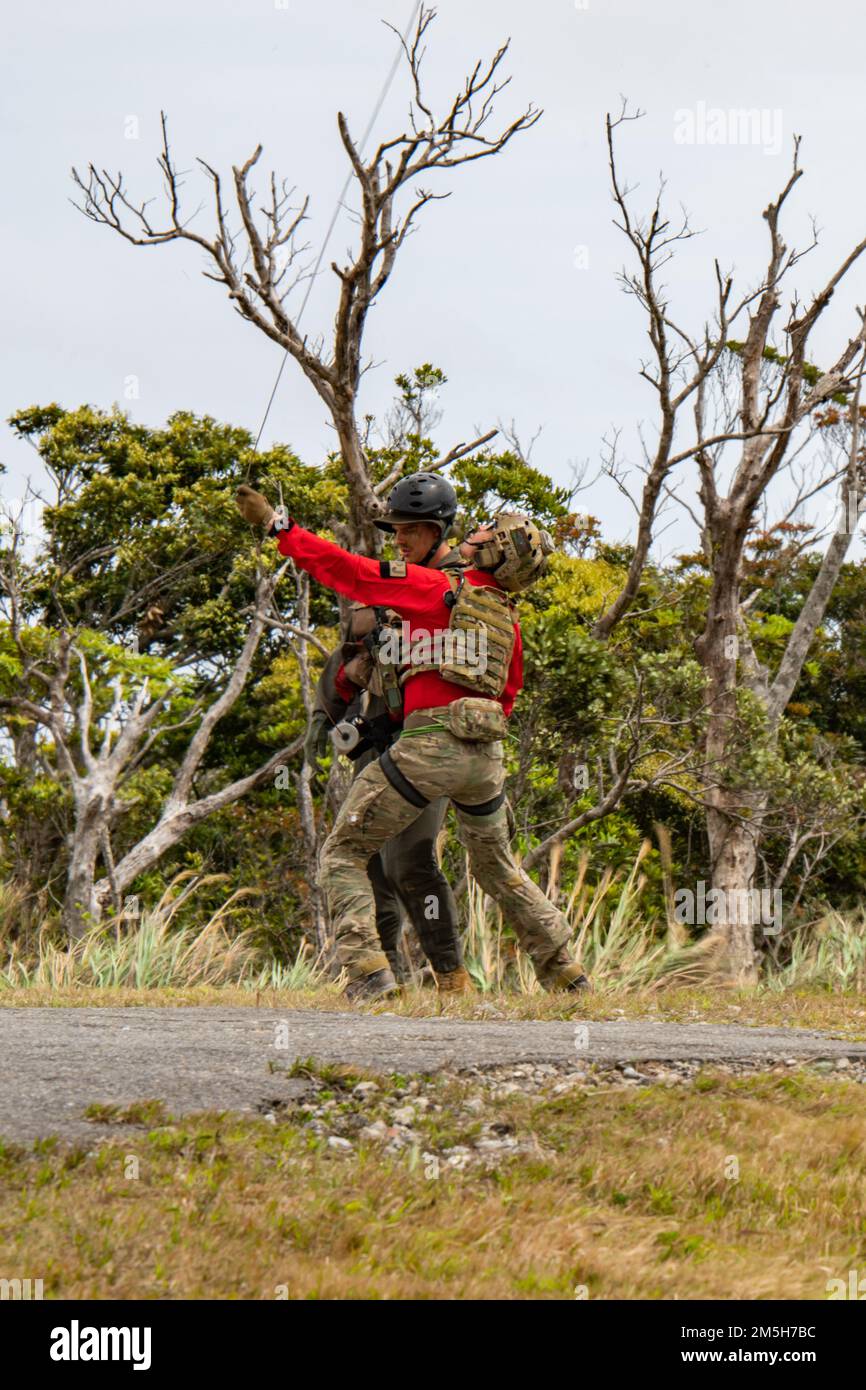 A 31st Rescue Squadron pararescueman, right, checks the line attached ...