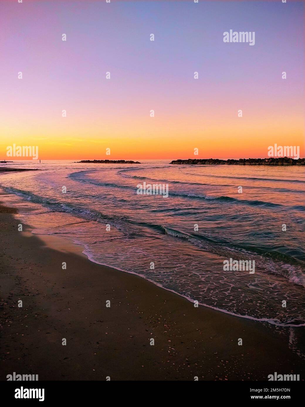 early morning sea, ocean during sunrise with red tons on the clouds ...