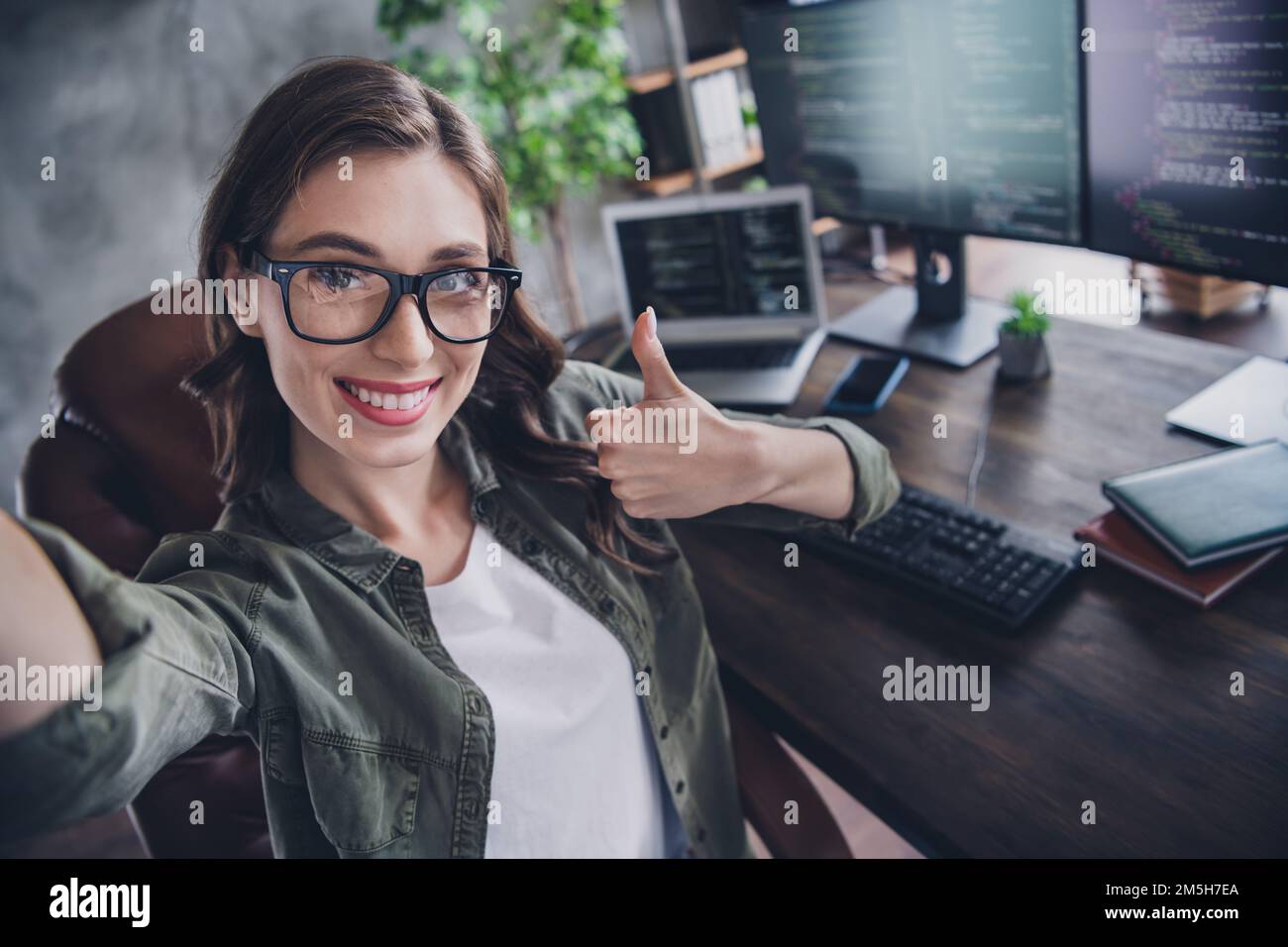 Photo of charming positive lady web designer developer thump up enjoy lovely work good results ...