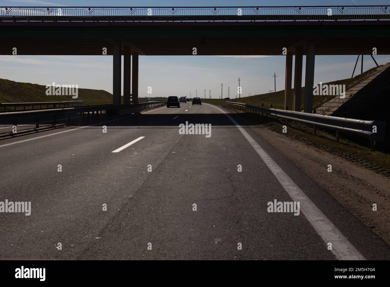 Bridge, roadside and asphalt, blue sky in the city streets in public ...