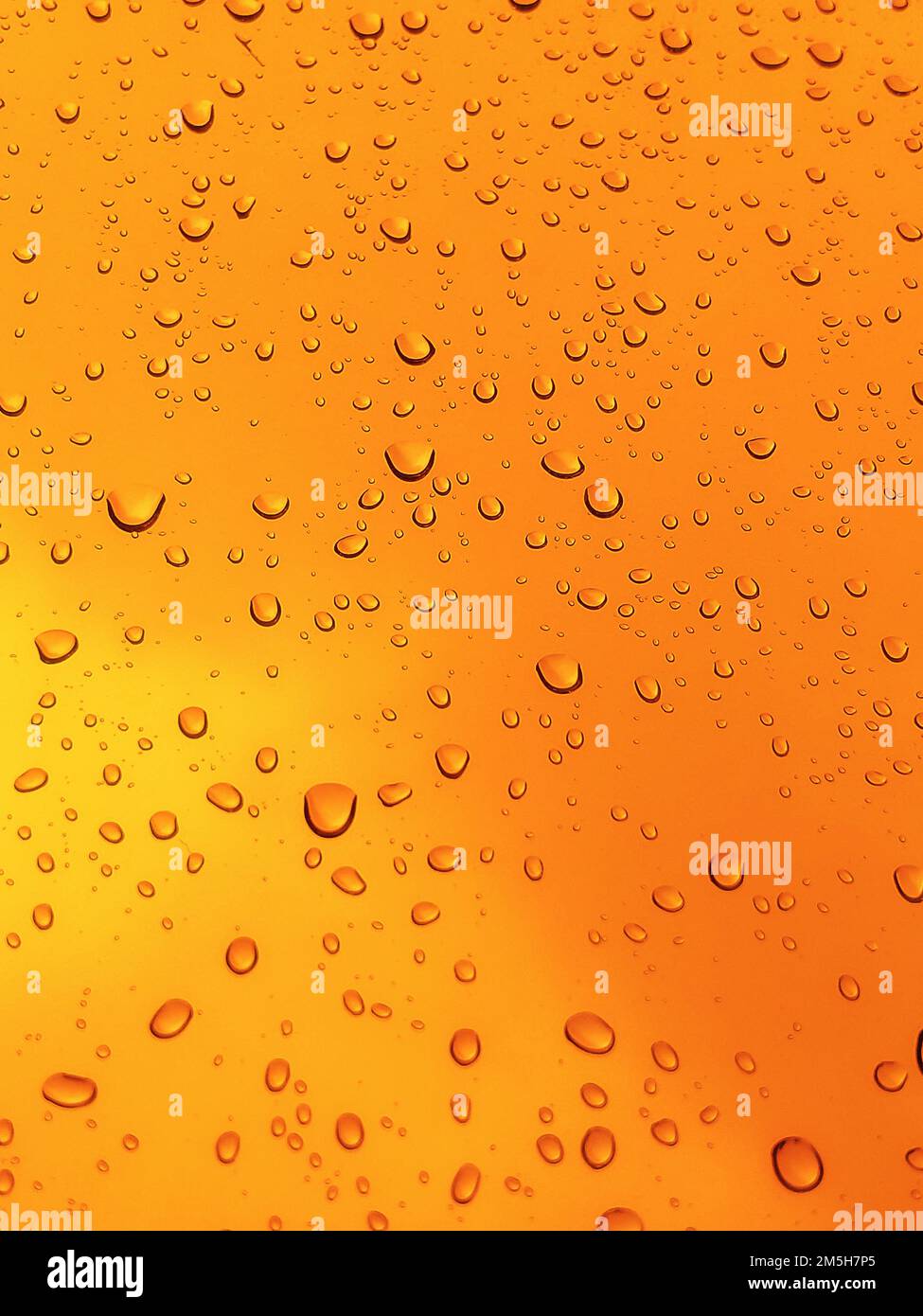 window raindrops on a orange background. rain droplet in a window Stock ...