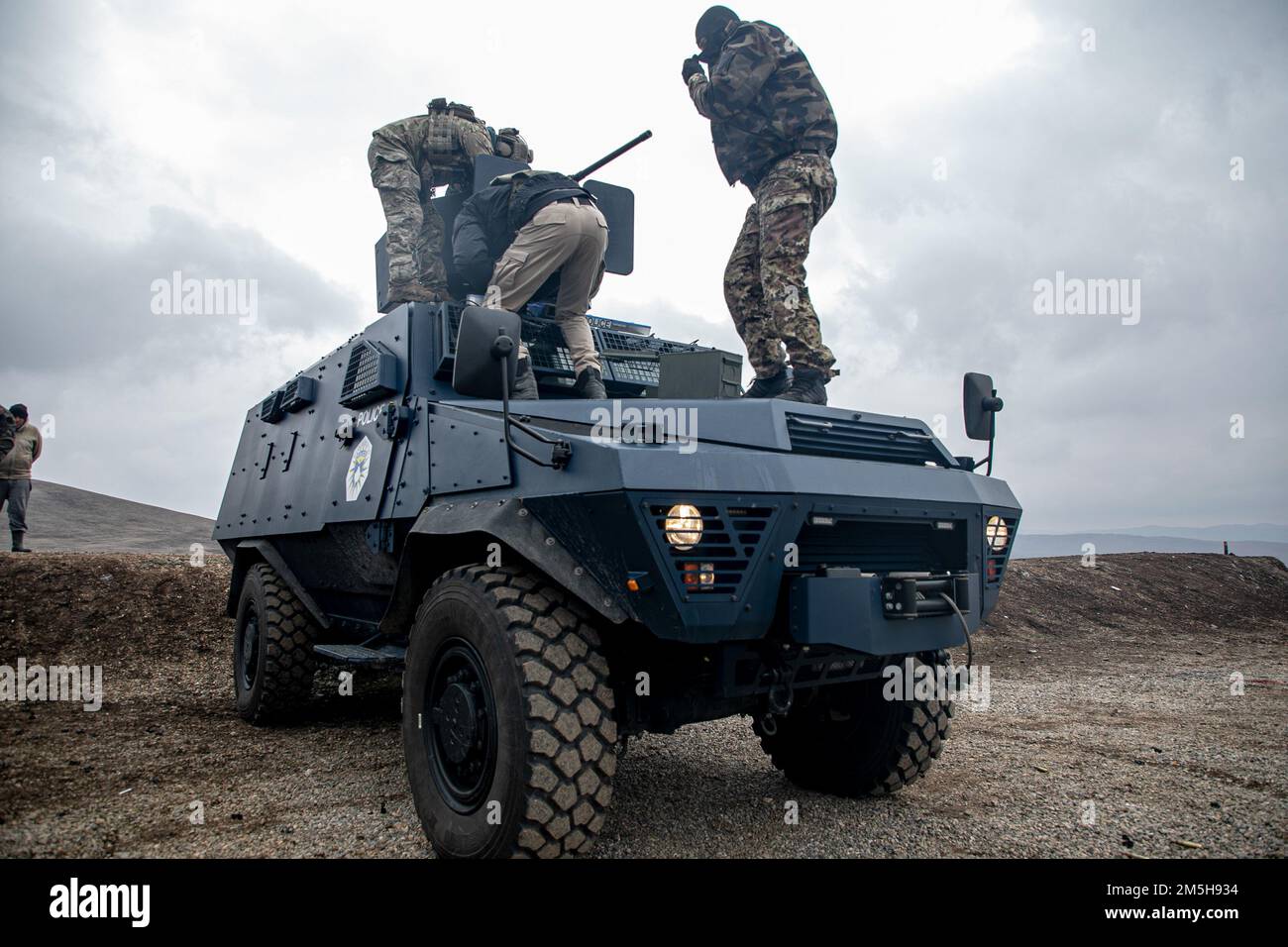 Members of 10th Special Forces stand on top of a tactical vehicle ...