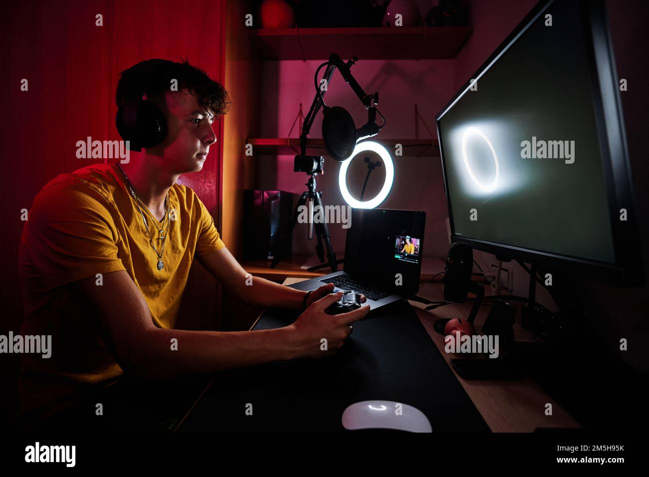 Youth gamer playing with a console and a screen Stock Photo - Alamy