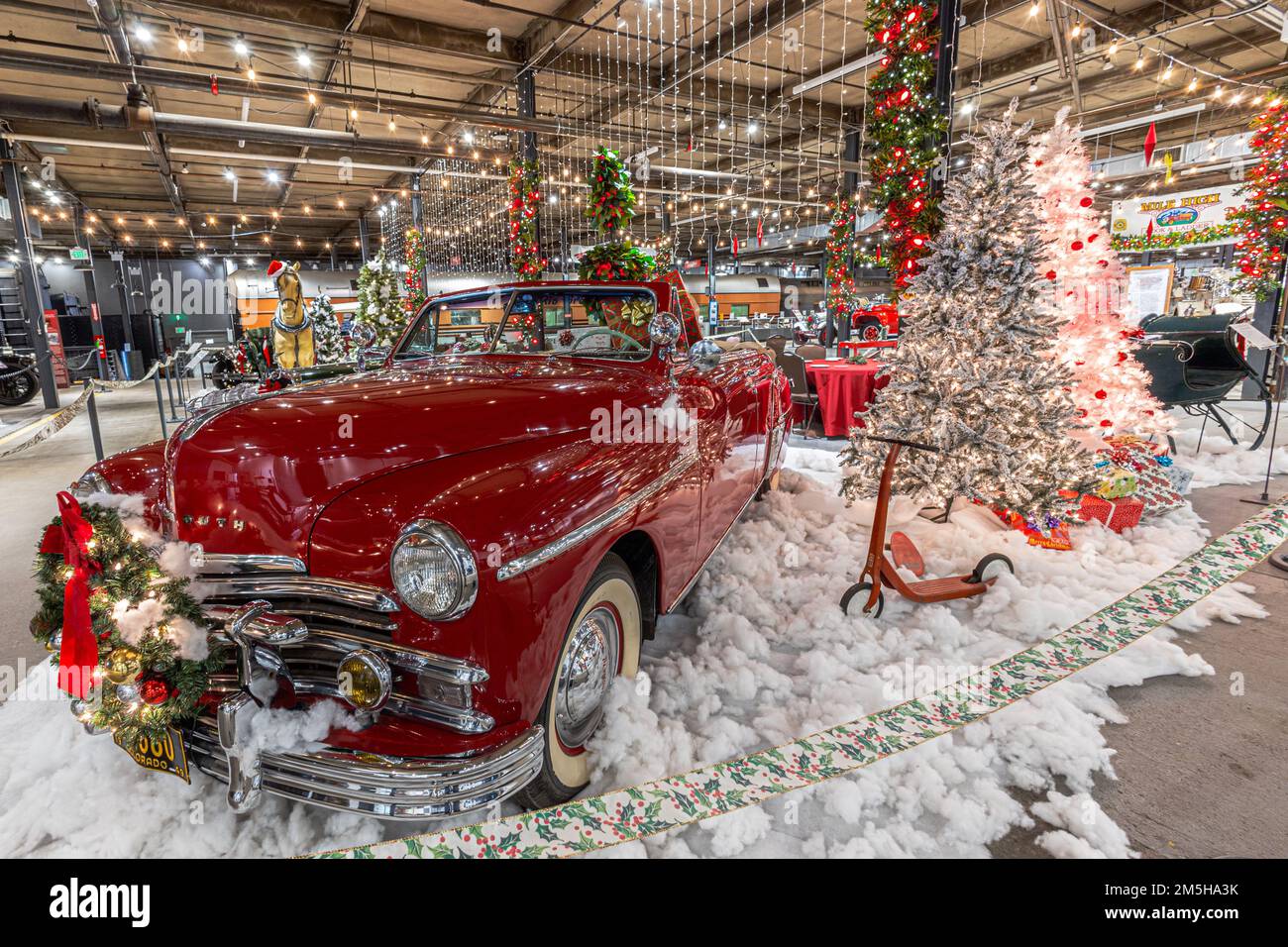A classic red car with fake snow and Christmas decorations at a museum ...