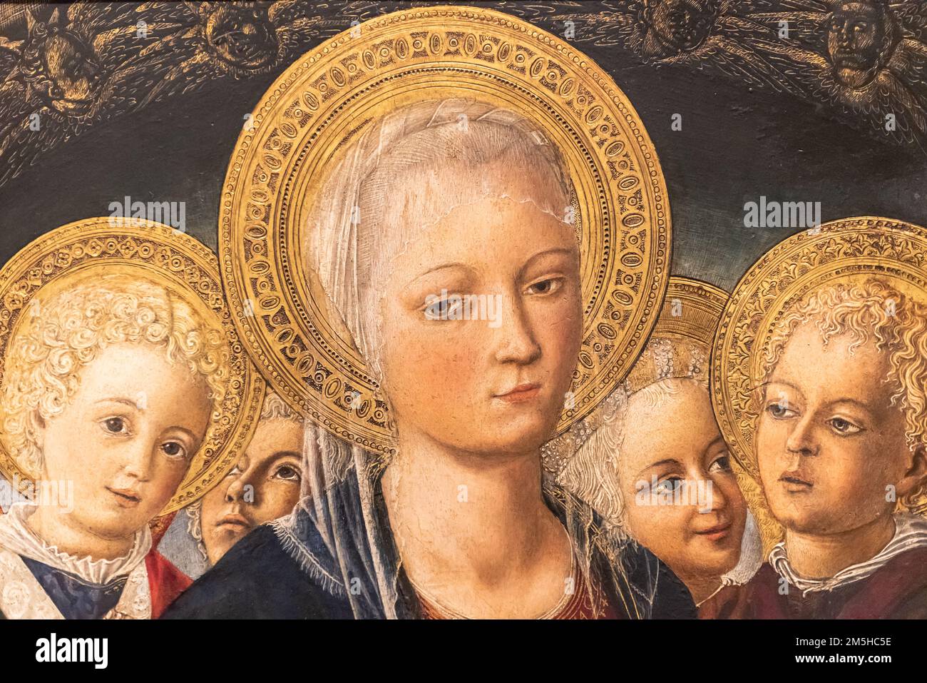Close-up on medieval religious painting showing a group of young ...
