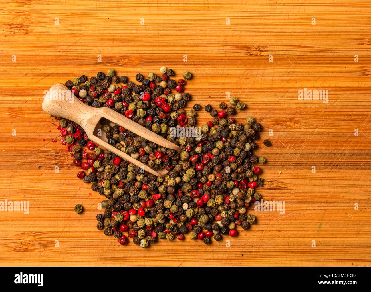 Wooden food background with spices. A mixture of peppers with a wooden ...