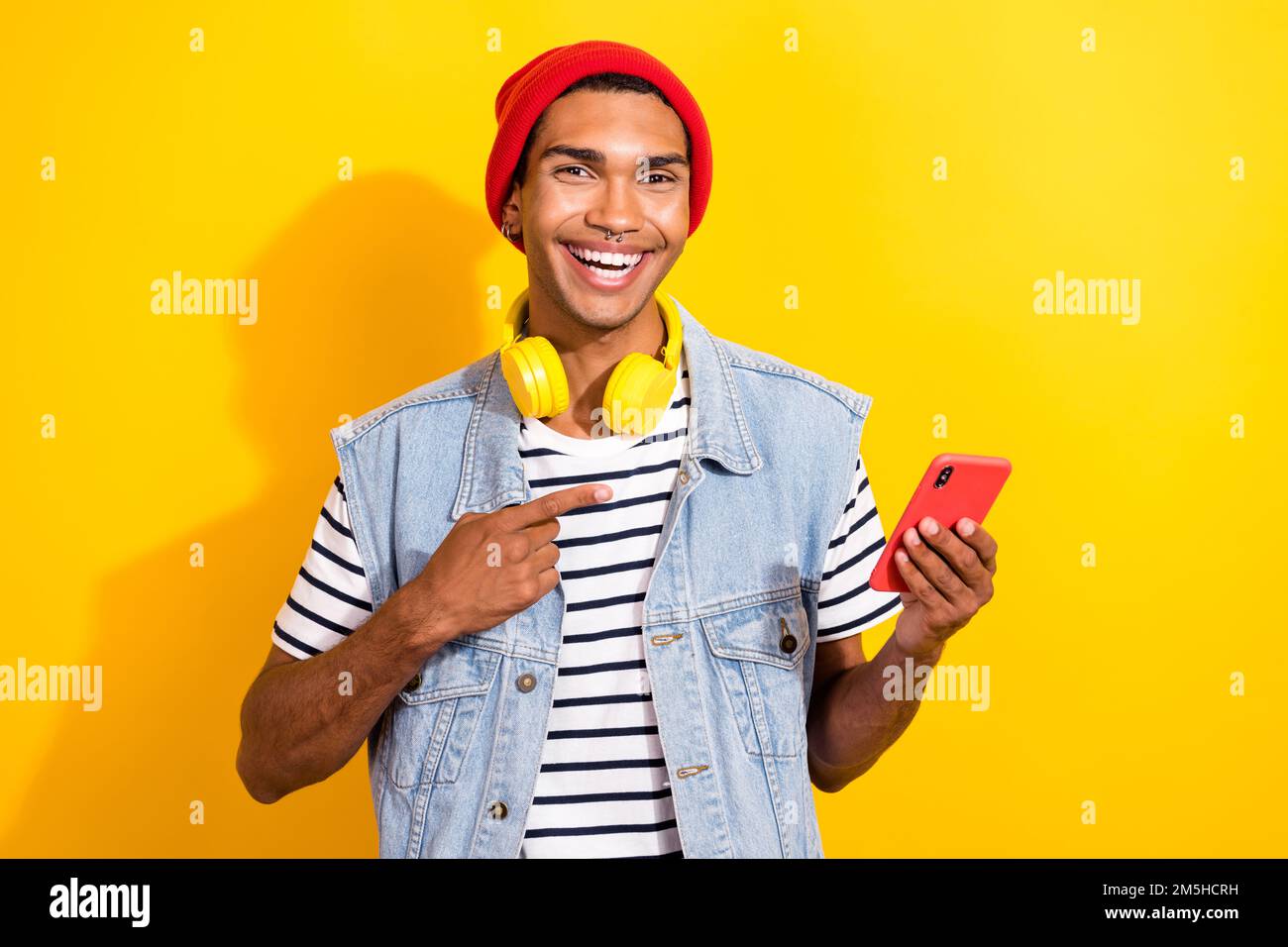 Photo of positive funny guy user wear trendy clothes promoting device ...