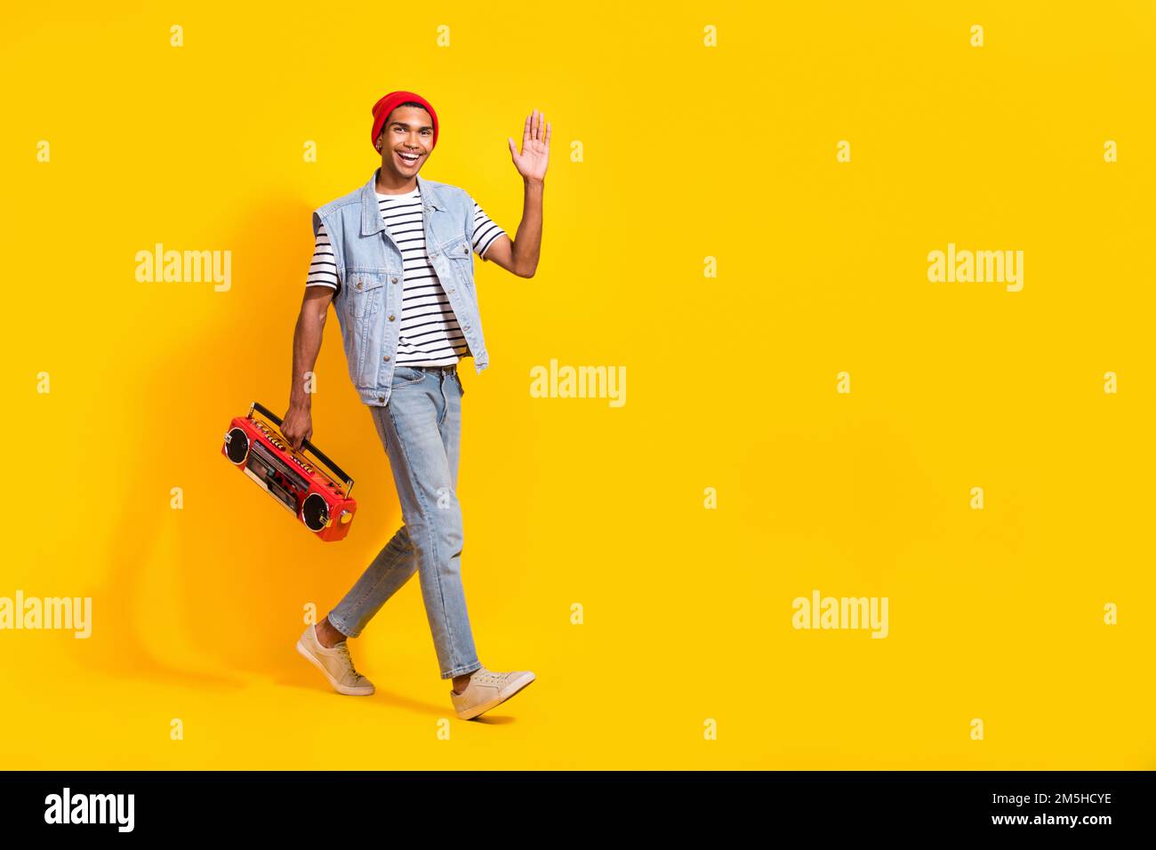 Full body profile portrait of positive person hold boombox arm palm ...