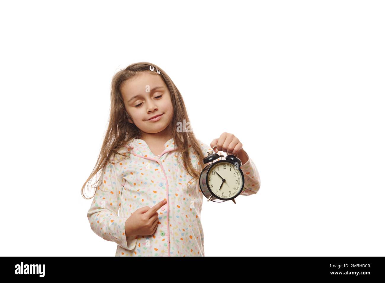 Falling asleep sleepy little child girl in white pajamas posing with ...