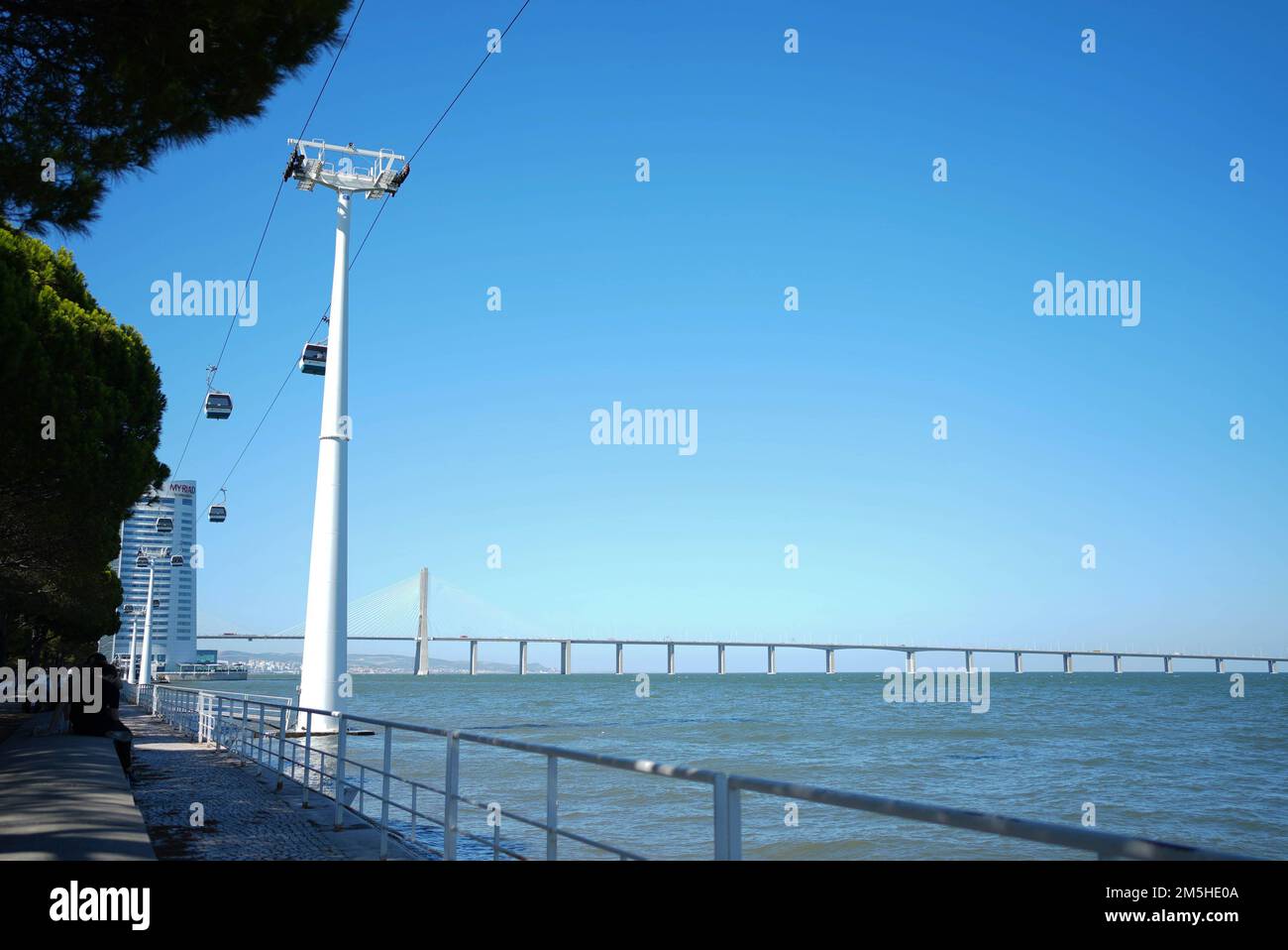 cable lift cabins above the sea and a distant bridge Stock Photo - Alamy