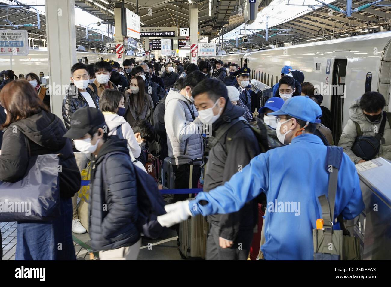 A shinkansen bullet train platform at JR Tokyo Station is crowded on Dec. 29, 2022, with people ...