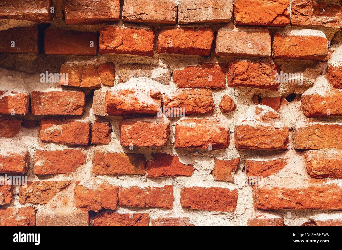 The wall of old red brick is damaged. Broken House Stock Photo - Alamy