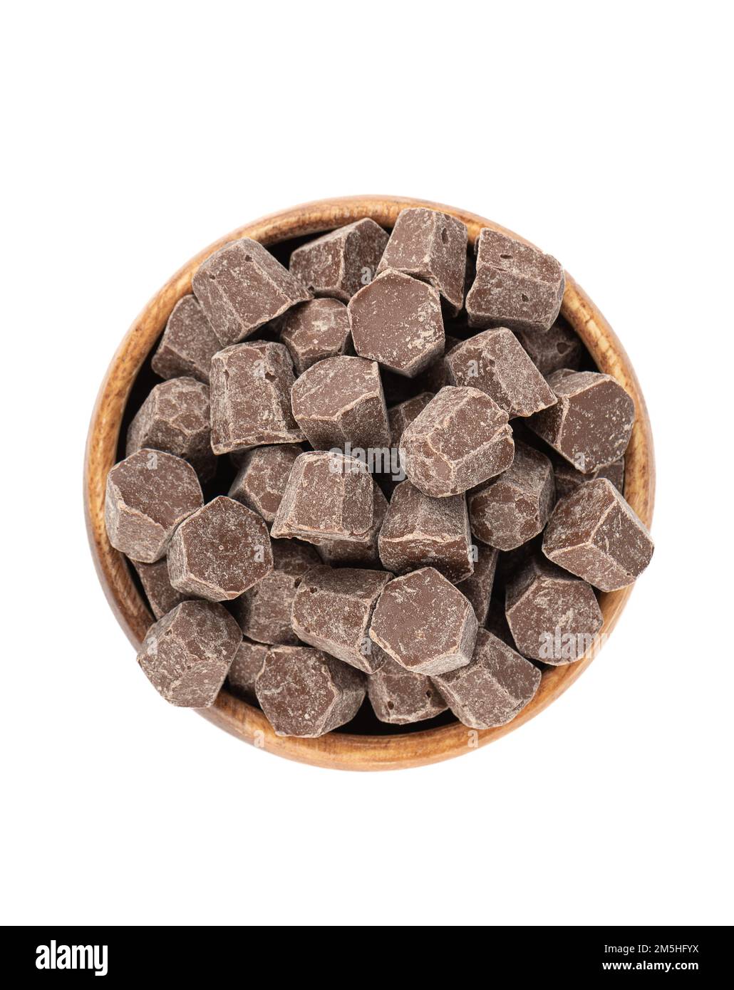 Top view of a wooden bowl full of diamond-shaped chocolate. White ...