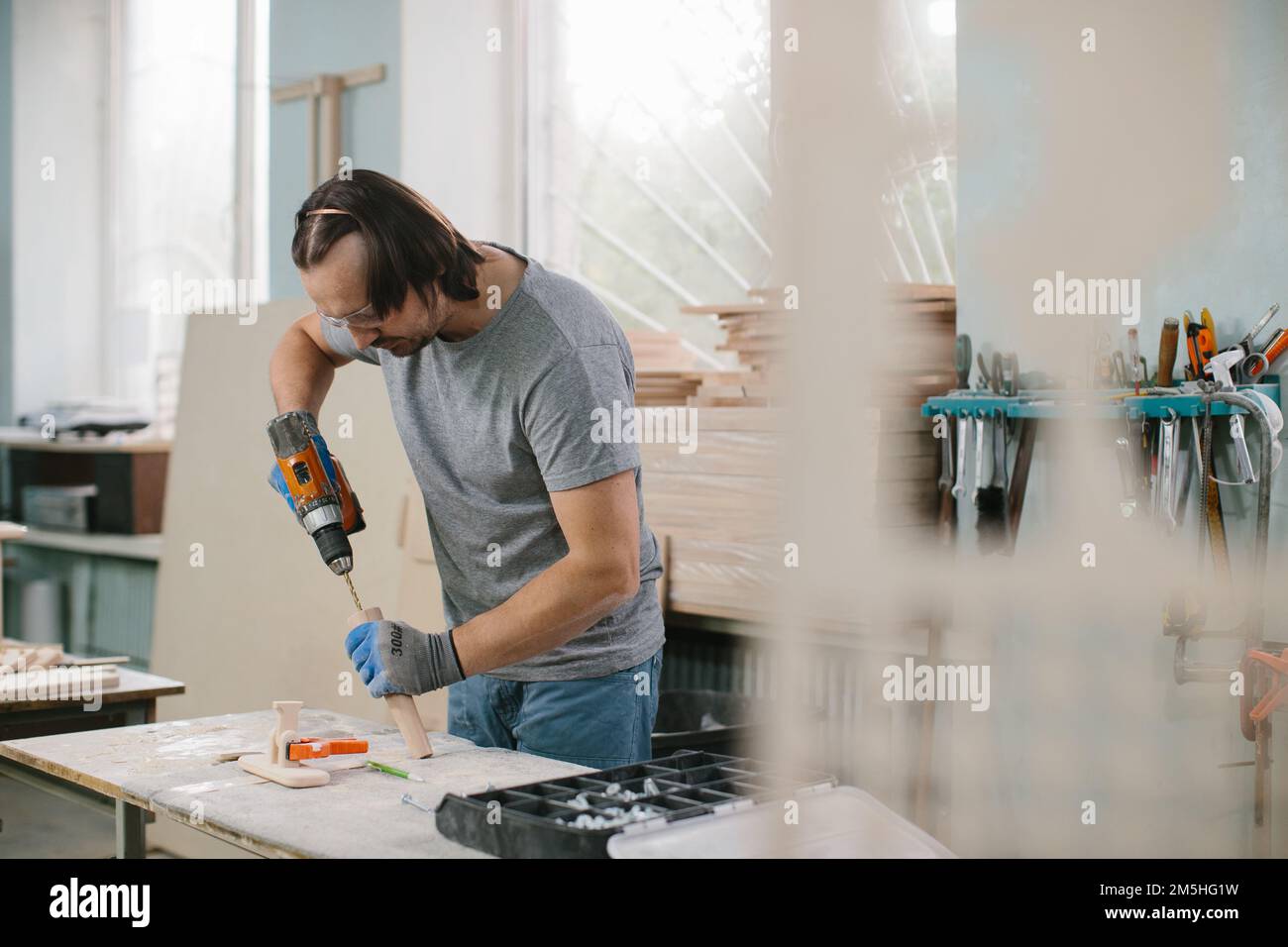 Carpenter drills a hole with an electrical drill Stock Photo - Alamy