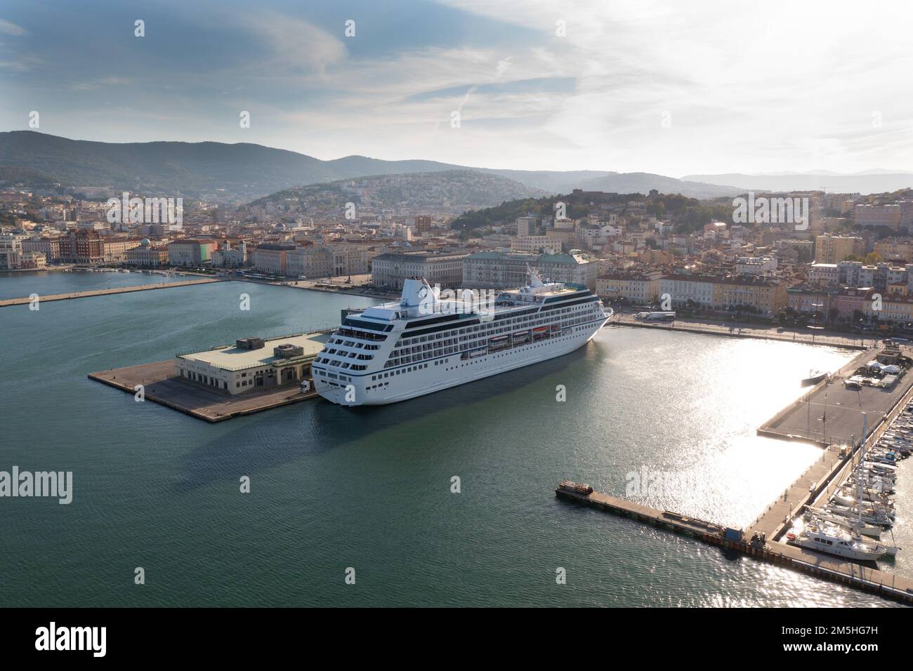 A drone shot of the nautical and a cruise ship MSC Fantasia anchored in ...