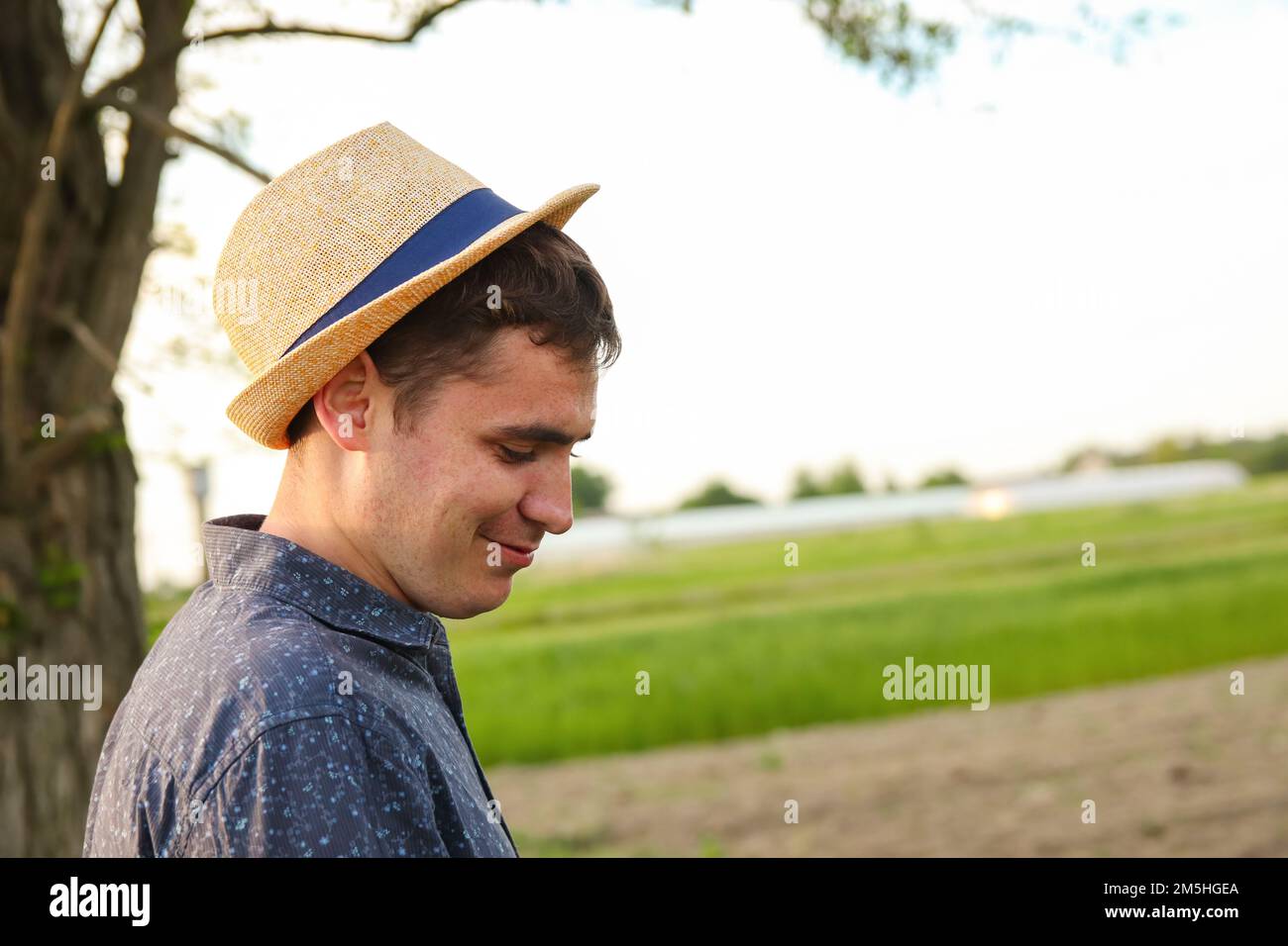 Defocus farmer in hat working on field with greenhouse outdoor ... Defocus farmer in hat working on field with greenhouse outdoor ...
