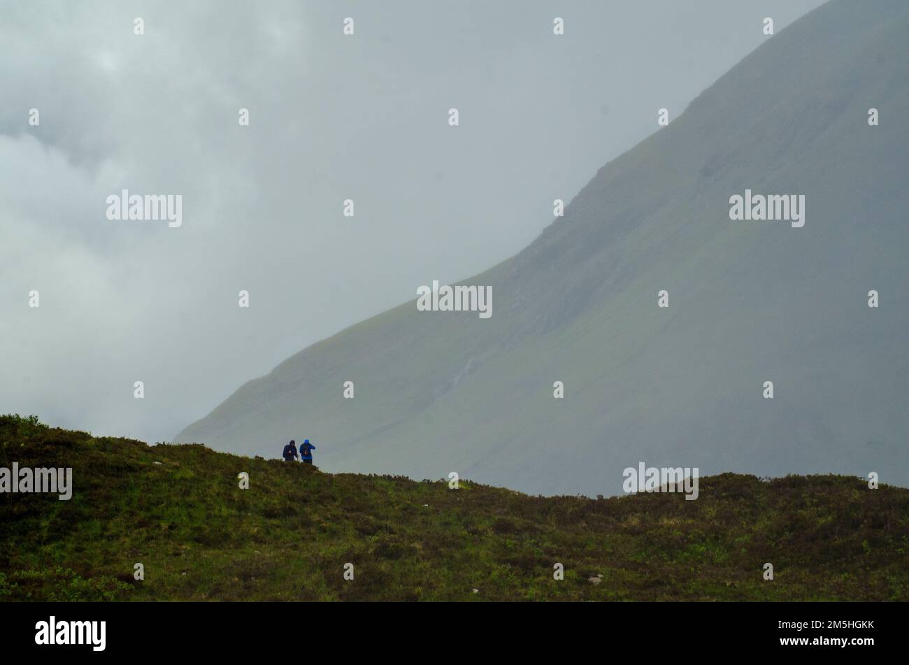 Two trekkers brave rainy spring weather on a trail in the Red Cullins ...
