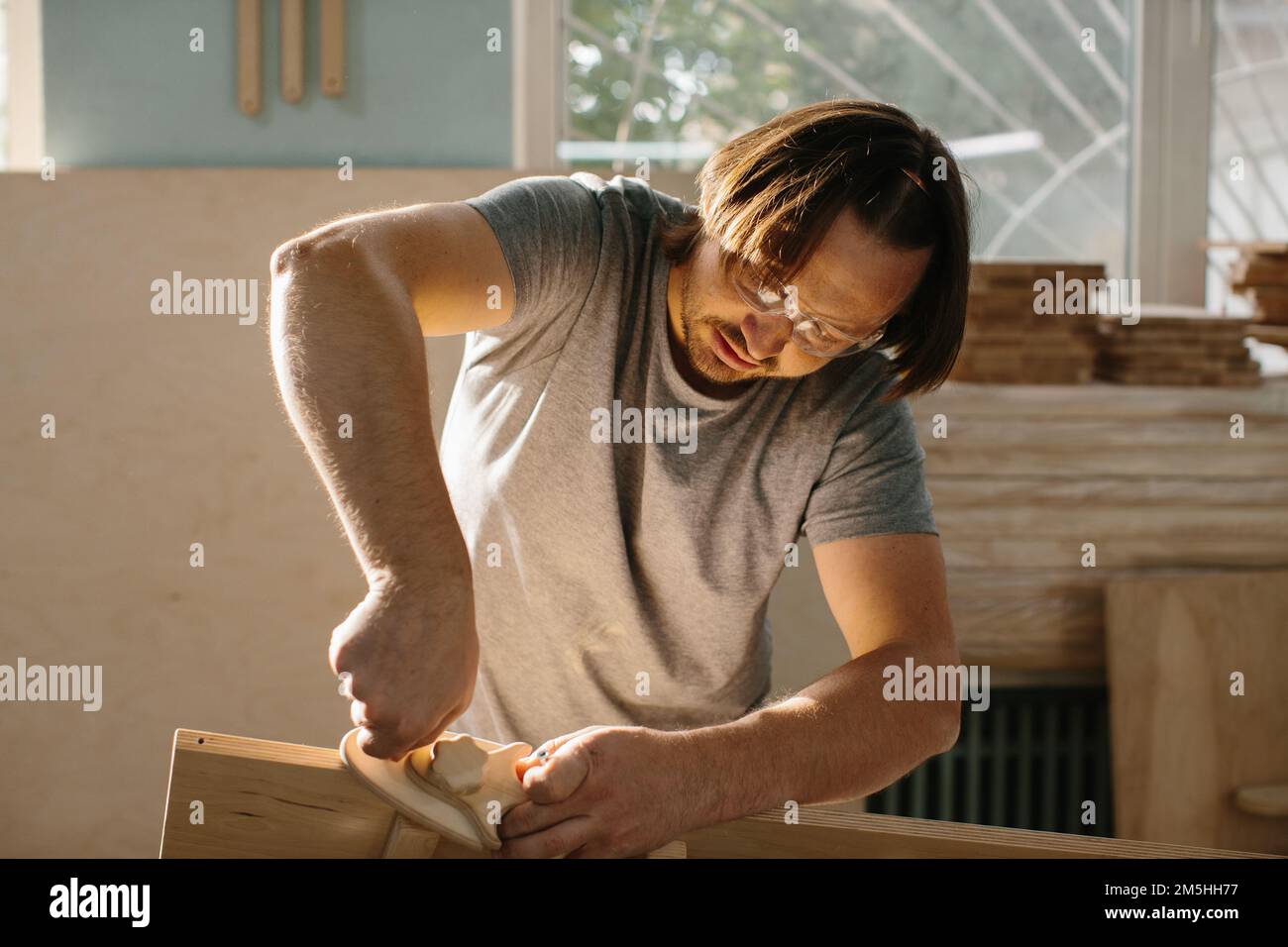 A carpenter makes a Montessori climbing set for children in his ...