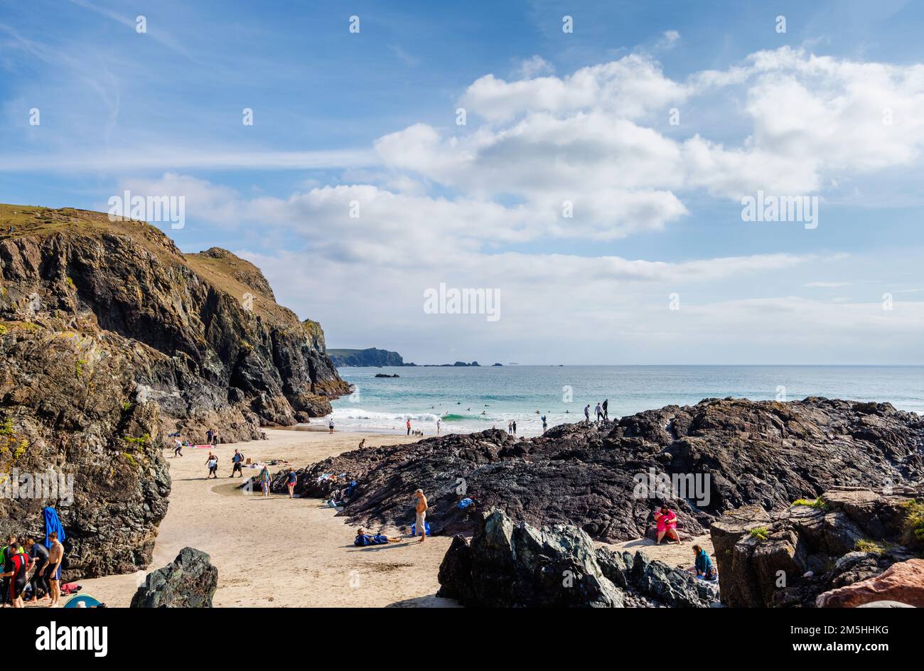 View of the sandy and rocky beach and cliffs in afternoon sun at ...