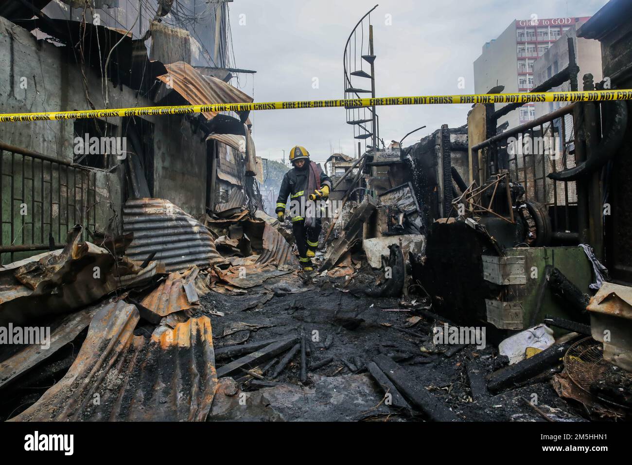 Manila, Philippines. 29th Dec, 2022. A firefighter walks through ...