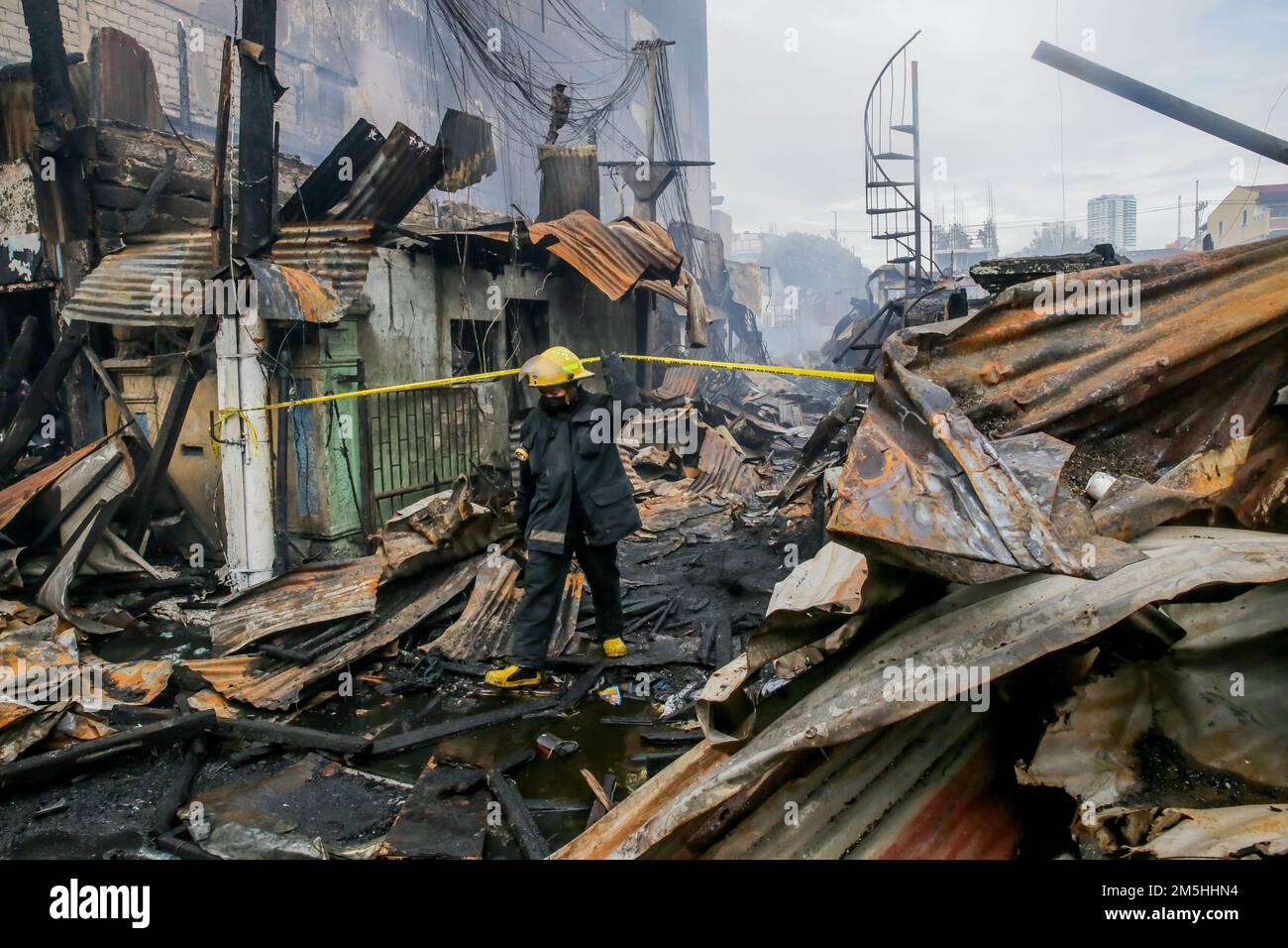 Manila, Philippines. 29th Dec, 2022. A firefighter walks through ...