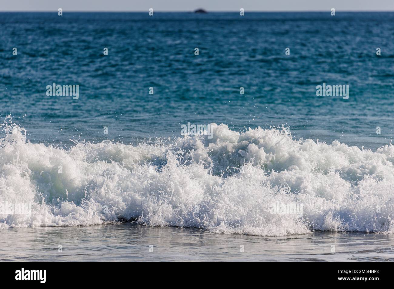 Breaking waves and surf seen from the beach at Kynance Cove on the ...