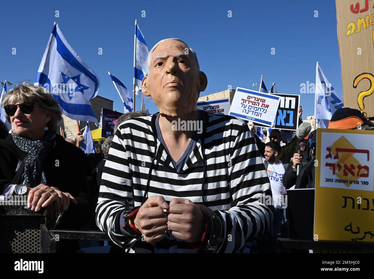 Jerusalem, Israel. 29th Dec, 2022. An Israeli activist wears a mask of ...