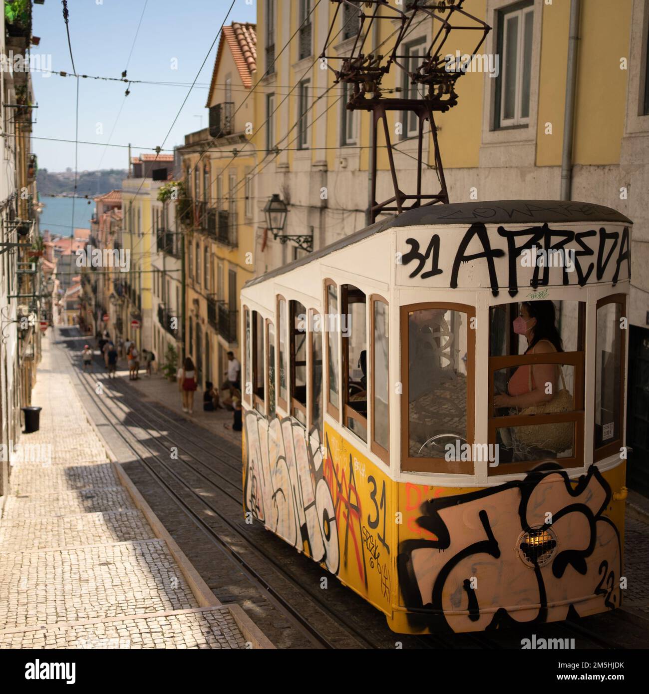 Graffitied small old tram going down the hill in the city Stock Photo ...