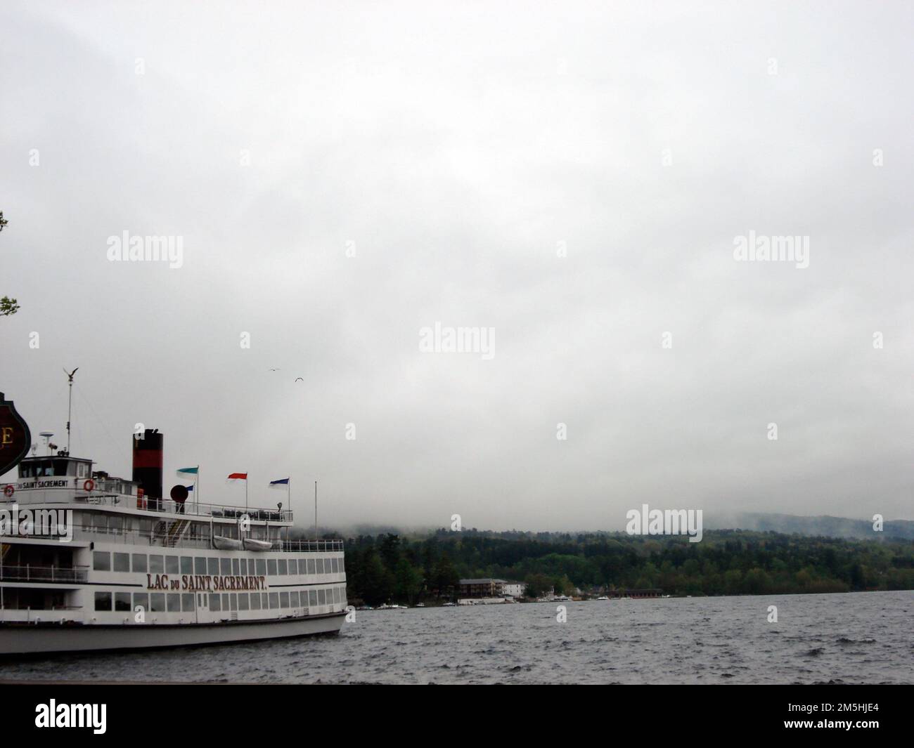 Lakes to Locks Passage - Boats on Lake George. An old boat crosses Lake ...