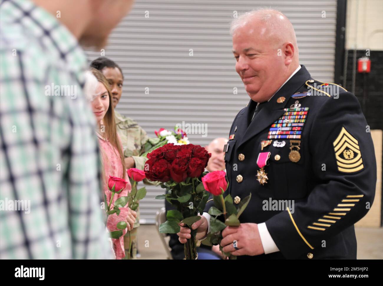 U.S. Army Command Sgt. Maj. Joseph Shirer gives flowers to his family ...