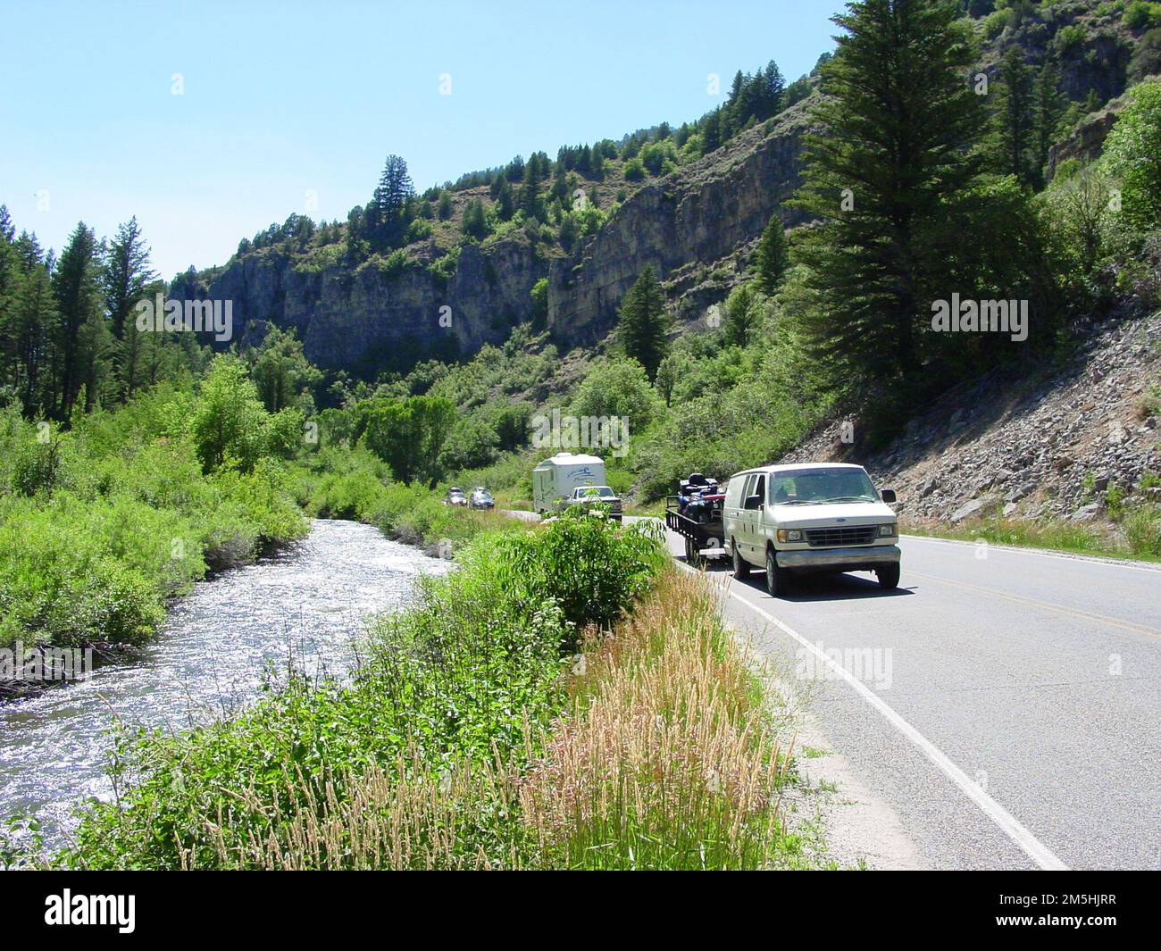 Logan Canyon Scenic Byway - River by Ricks Spring. Cars pass close to ...