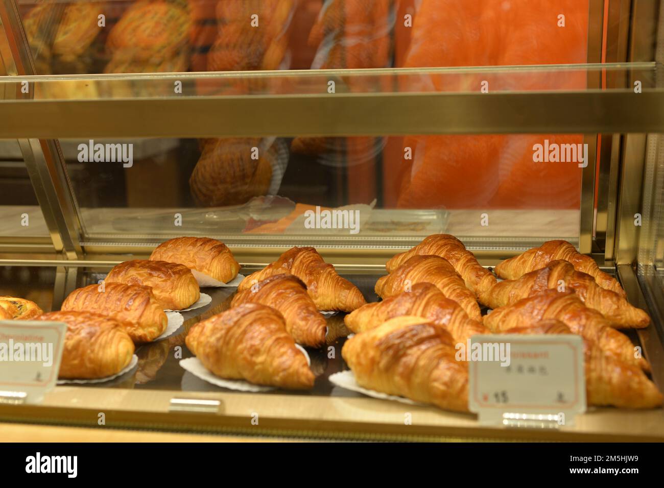 A closeup of freshly baked croissants on the display in a bakery Stock ...