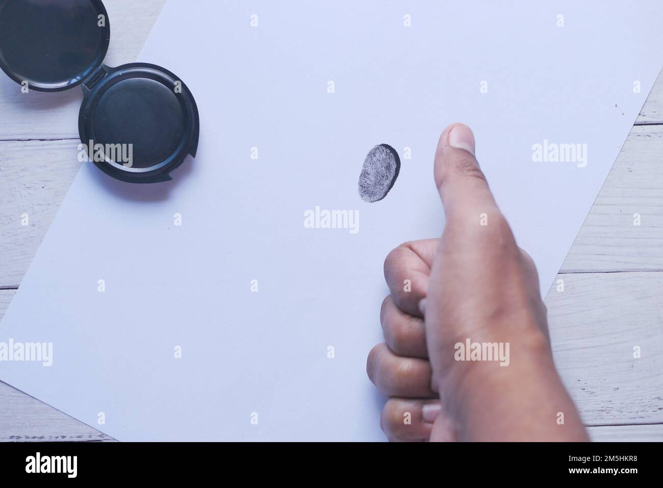 putting fingerprints on a paper close up Stock Photo - Alamy