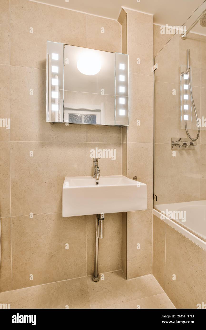a bathroom with a sink, mirror and bathtub on the wall in this photo is ...