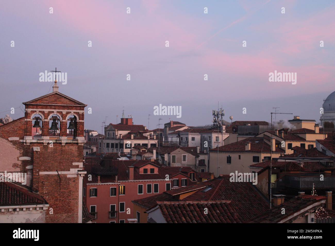 Pink sky, sunset view on the tiled rooftops of San Marco, Venice, Italy ...