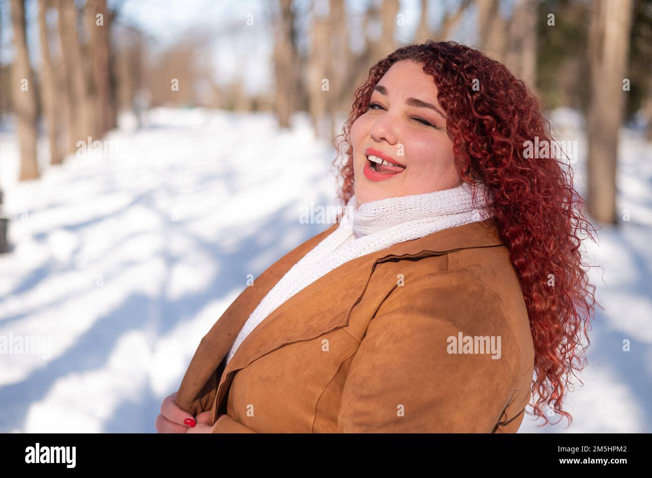 Cheerful fat caucasian woman walks in the park in winter Stock Photo ...