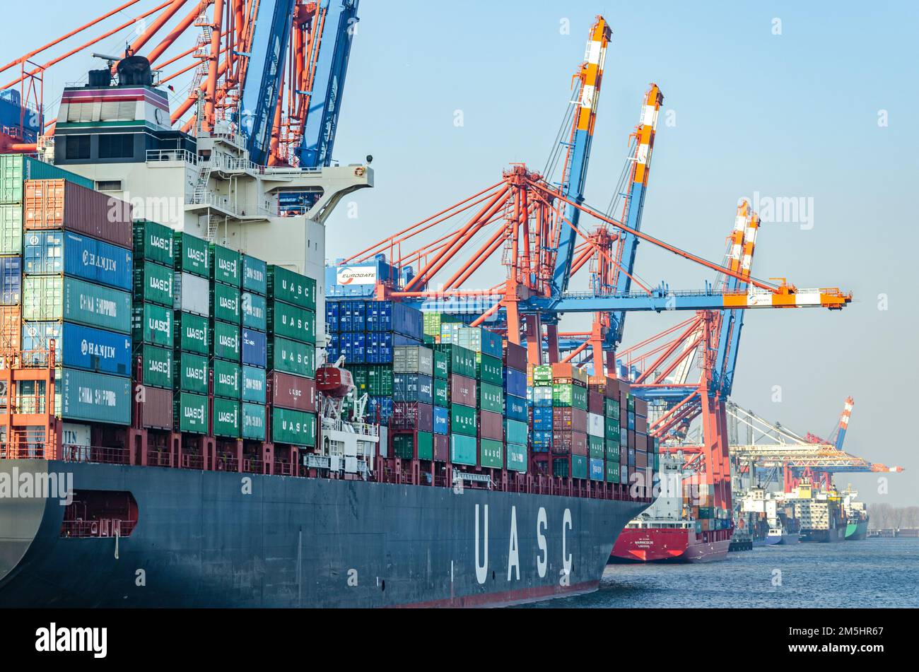 Closeup of large container vessel and harbour facilities at a the ...