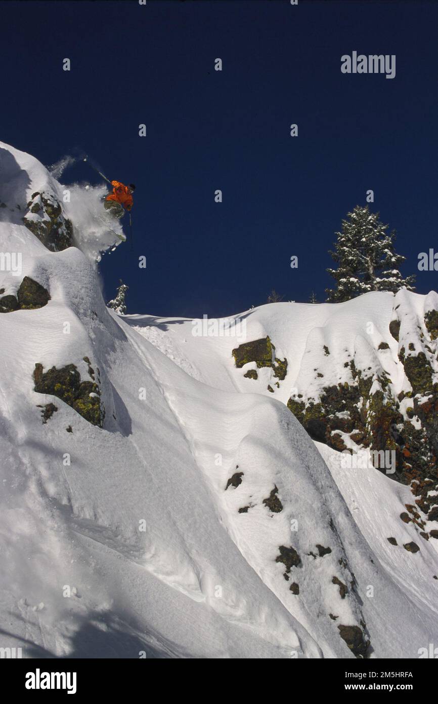 Ebbetts Pass Scenic Byway - Riding off a Cliff. A skier rides off a ...