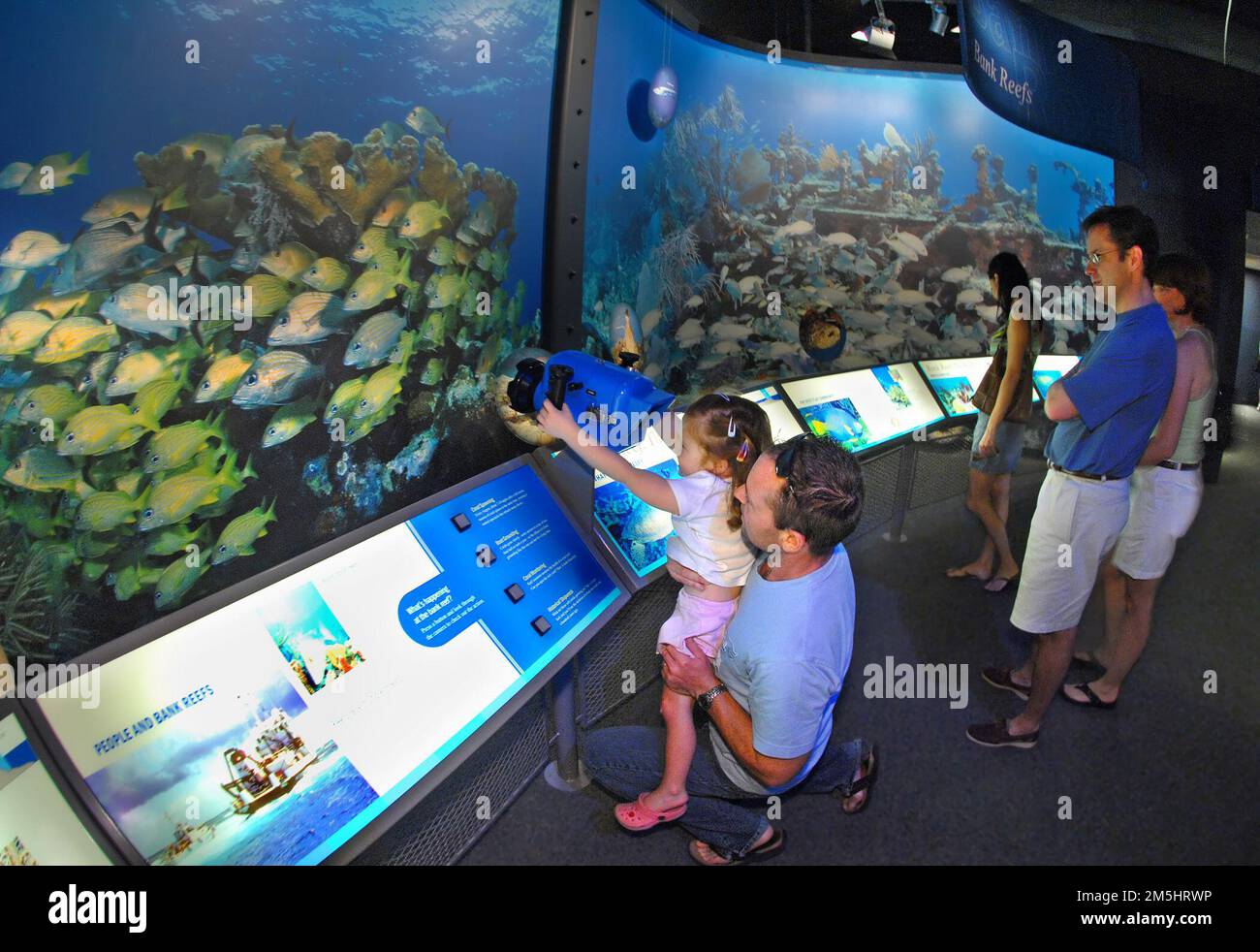 Eco-Discovery Center. A father helps his young daughter at an ...