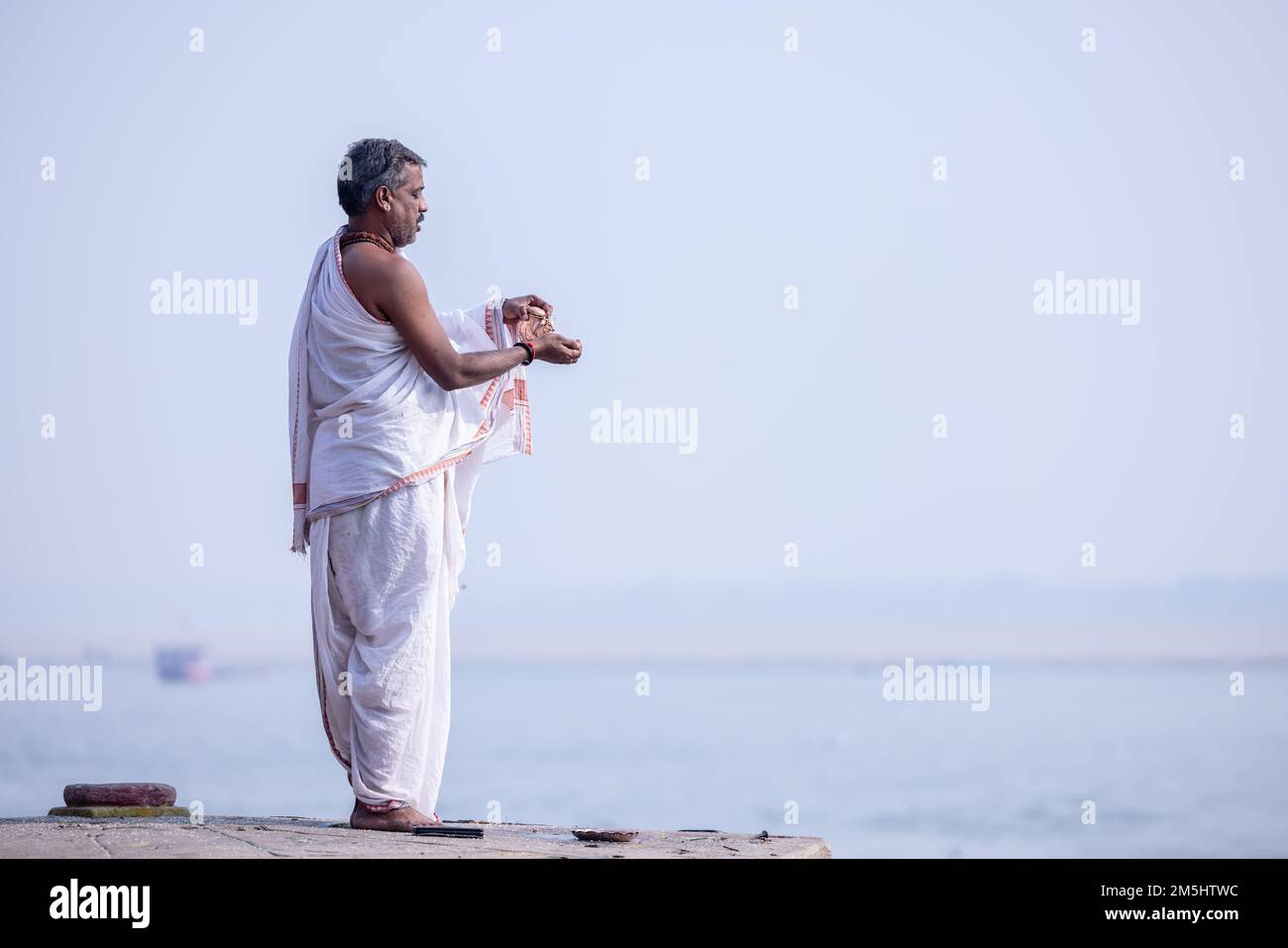 Varanasi, India: Portrait of Unidentified Indian sadhu baba worshiping lord sun in traditional ...