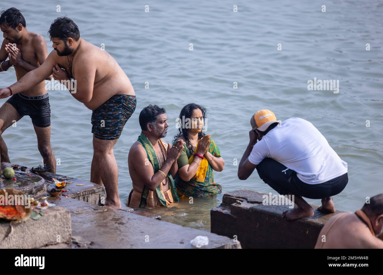 Varanasi, Uttar Pradesh, India - Nov 2022: Portrait on an south indian couple taking dip in holy ...