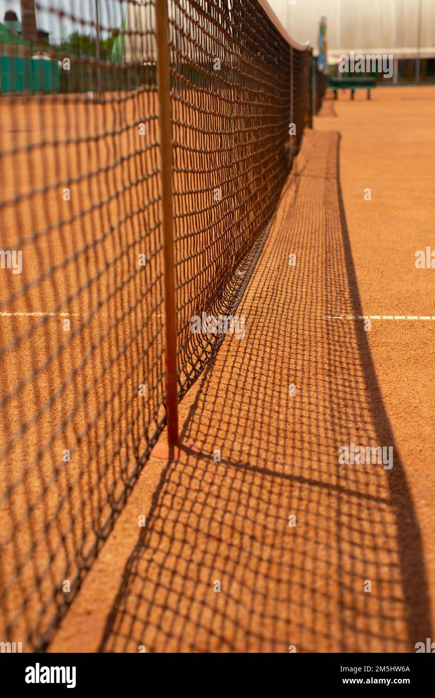 Tennis net and net shadow on a clay tennis court. Sports backgrounds ...